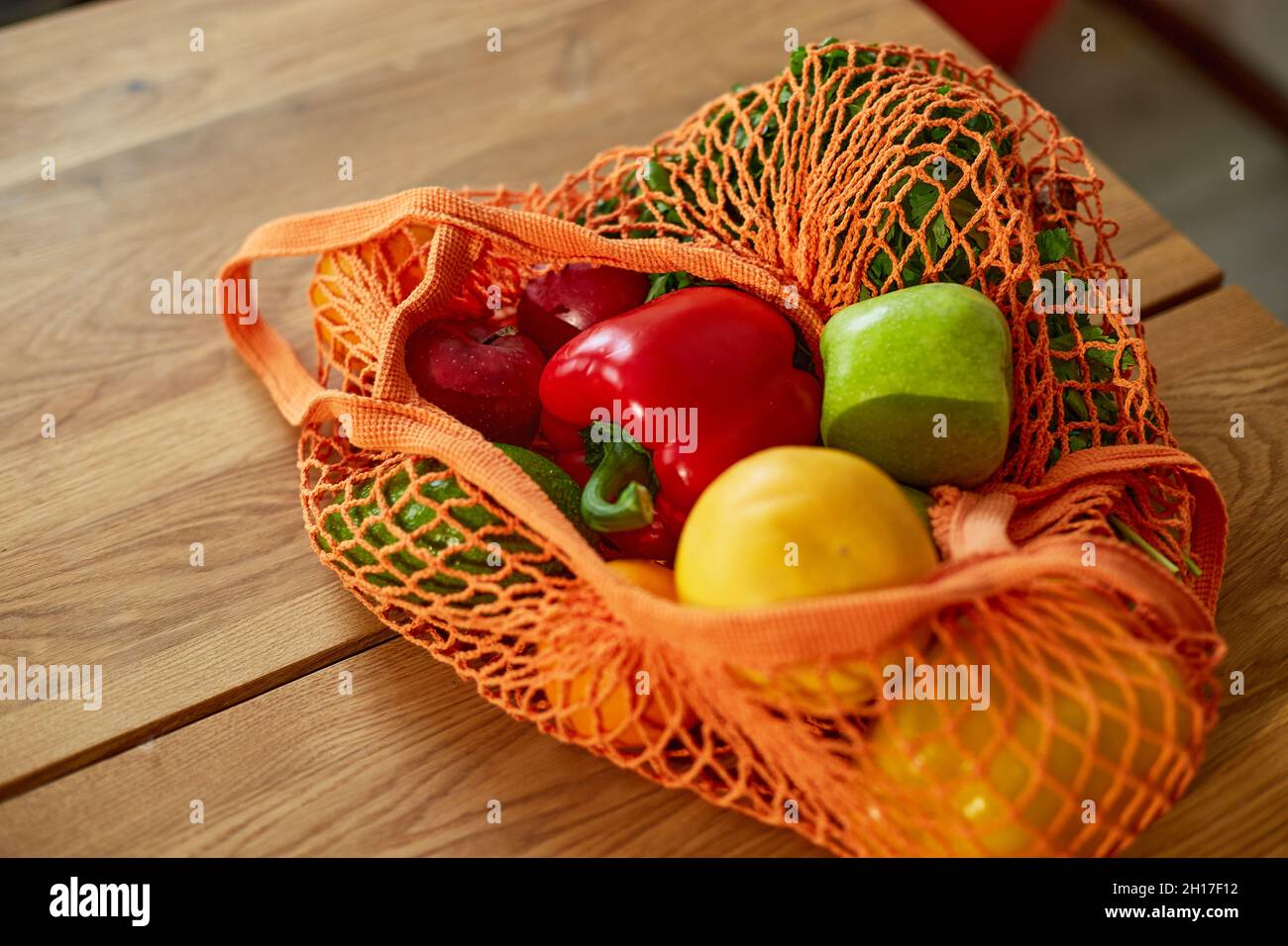 Shopping mesh eco bag with healthy vegan vegetables and fruits on the ...