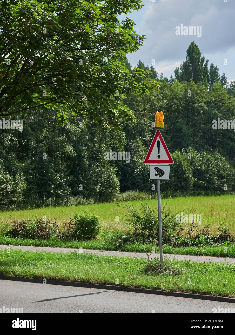 A frog warning sign on a road crossing where frogs wander Stock Photo ...