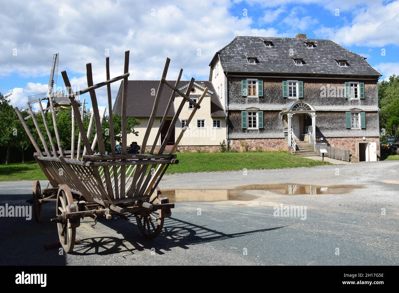 Hay cart in front of an old Hessian farmhouse Stock Photo - Alamy