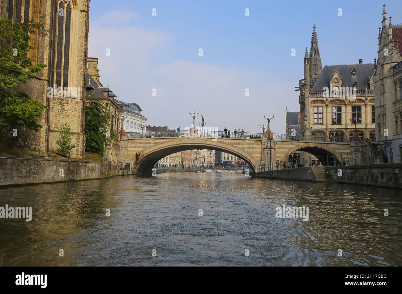 Gent, Belgium - October 9. 2021: View over water canal beyond medieval ...