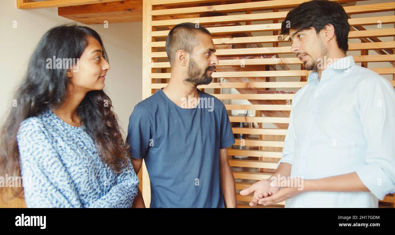 A group of Indian friends in a living room, talking and laughing Stock ...