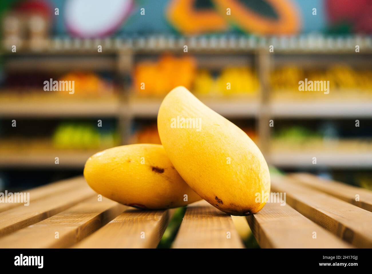 Close-up front view of fresh juicy pineapple standing on wooden pallet ...