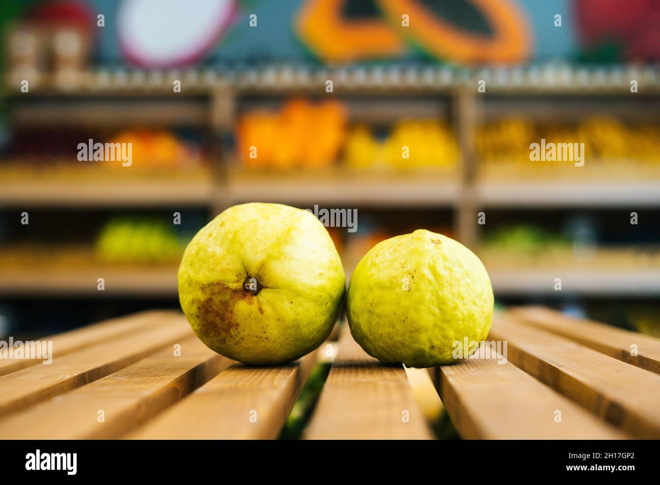 Close-up front view of fresh juicy ripe salak lying on wooden pallet at ...