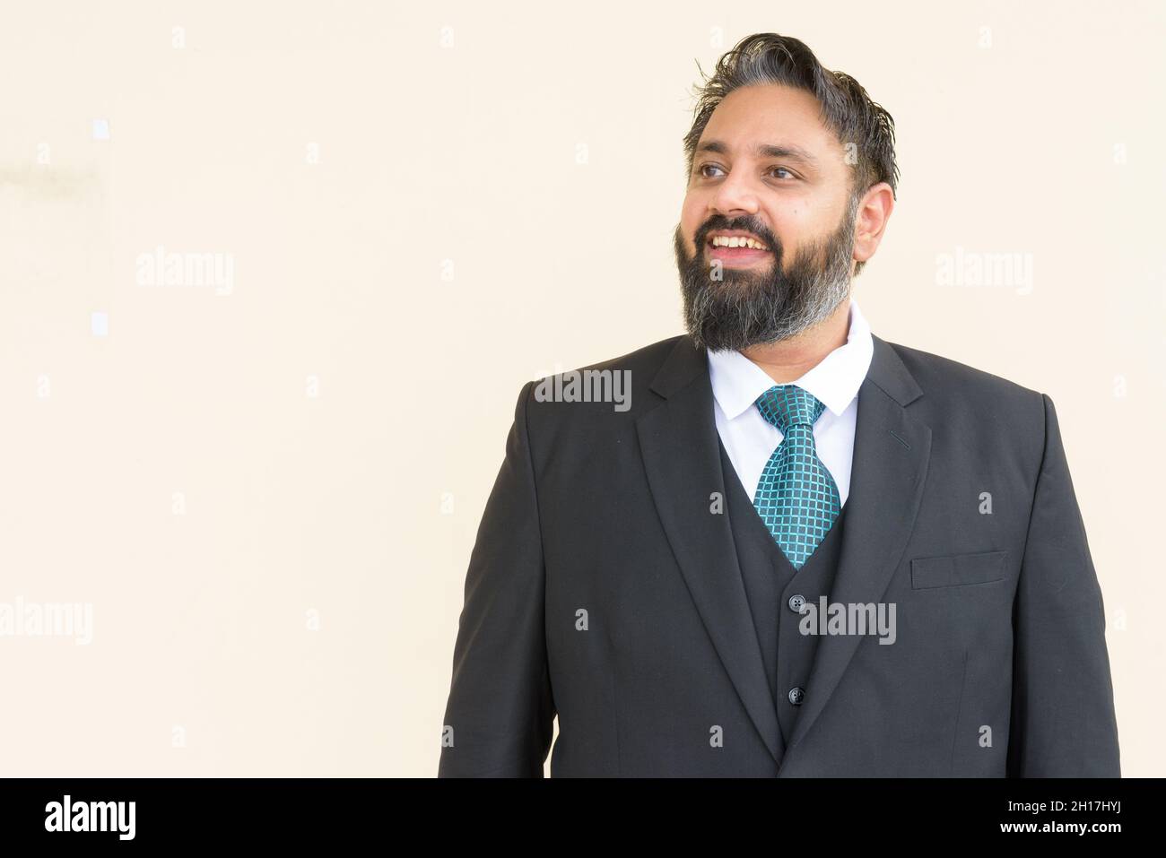 Portrait of handsome Indian businessman against plain background Stock ...