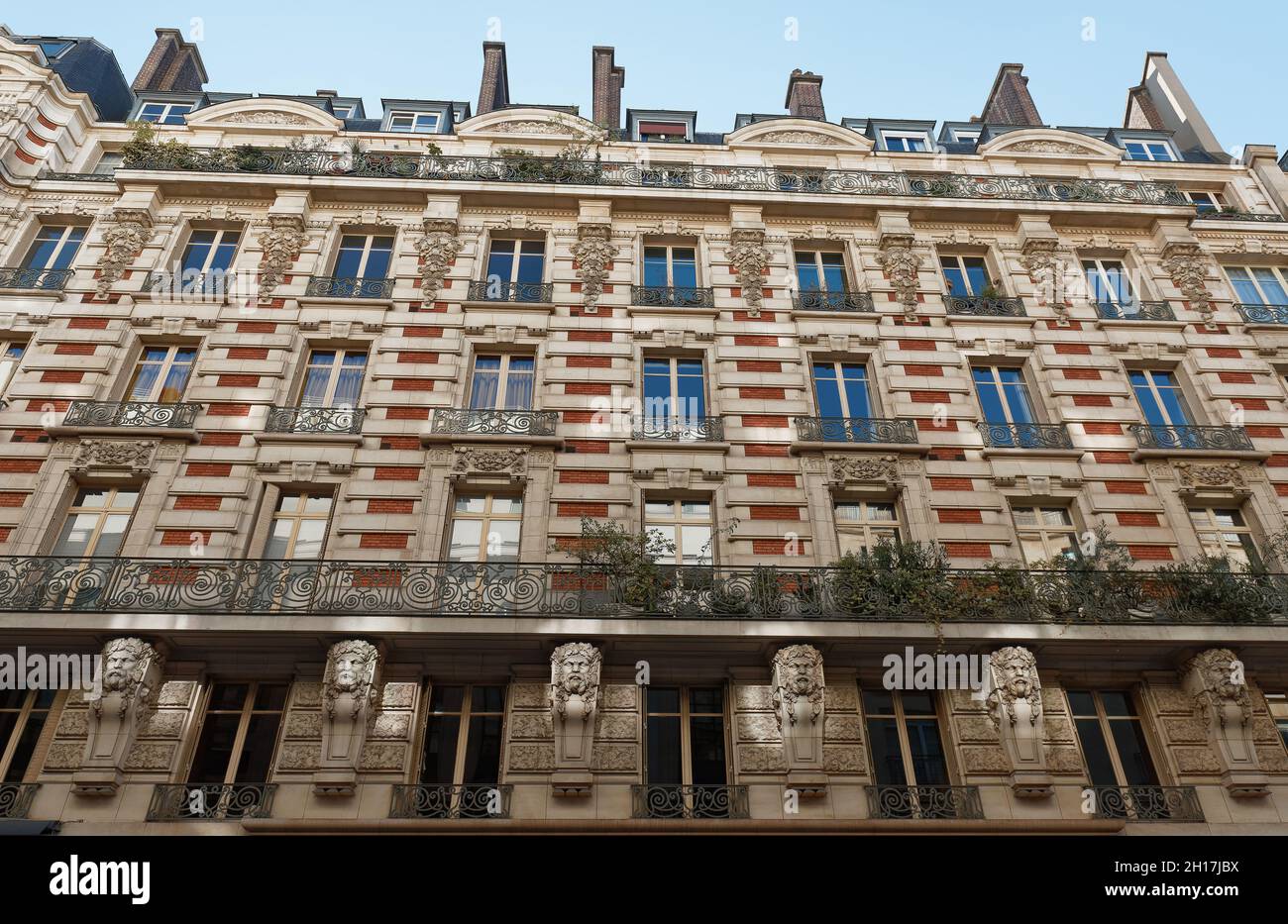 The facade of traditional French house with typical balconies and ...