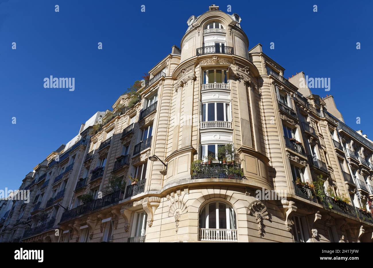 The facade of traditional French house with typical balconies and ...