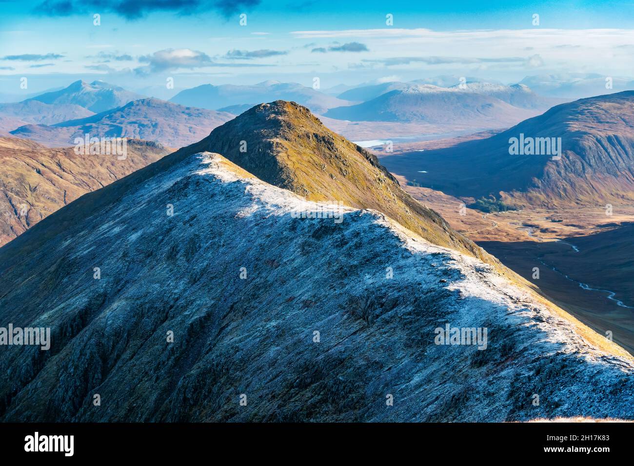Walker descends from Stob Coire Raineach along the Buachaille Etive ...