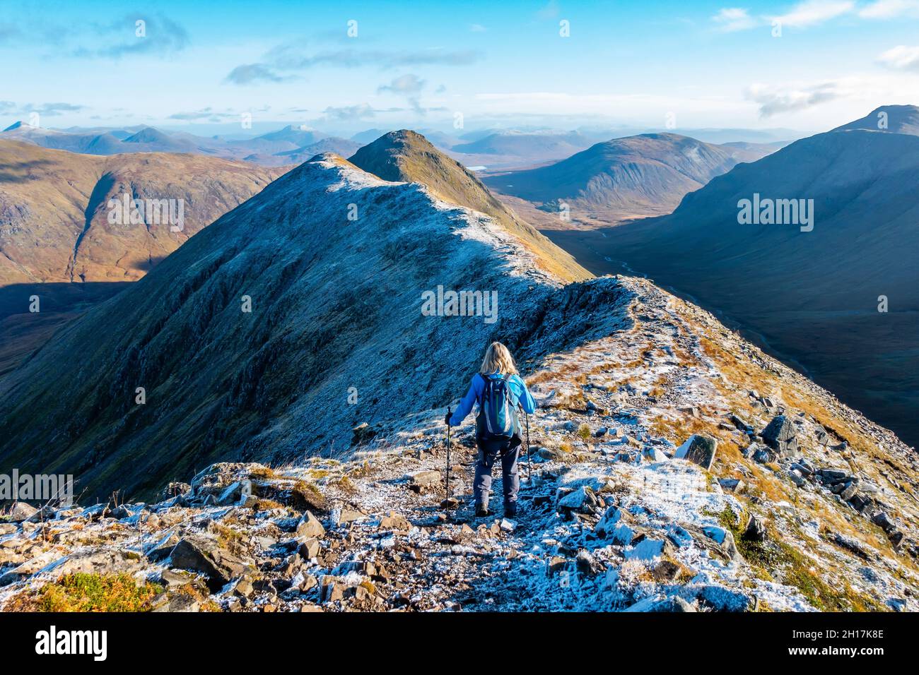 Walker descends from Stob Coire Raineach along the Buachaille Etive ...
