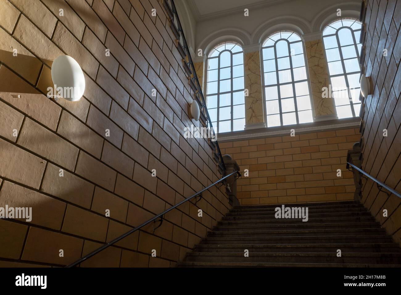 Interior view of staircase with high ceiling, window and natural ...