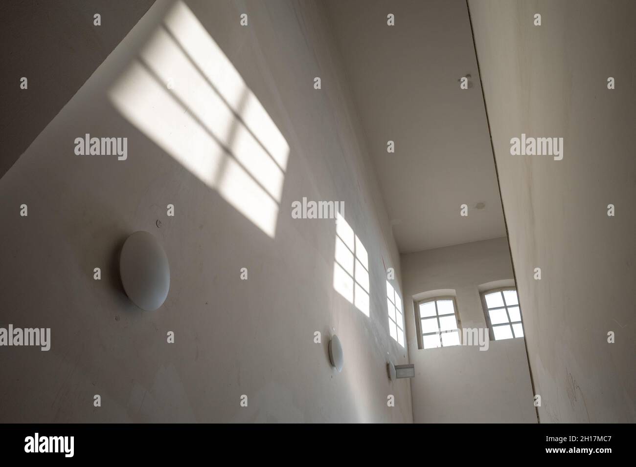 Interior view of staircase with high ceiling, window and natural ...