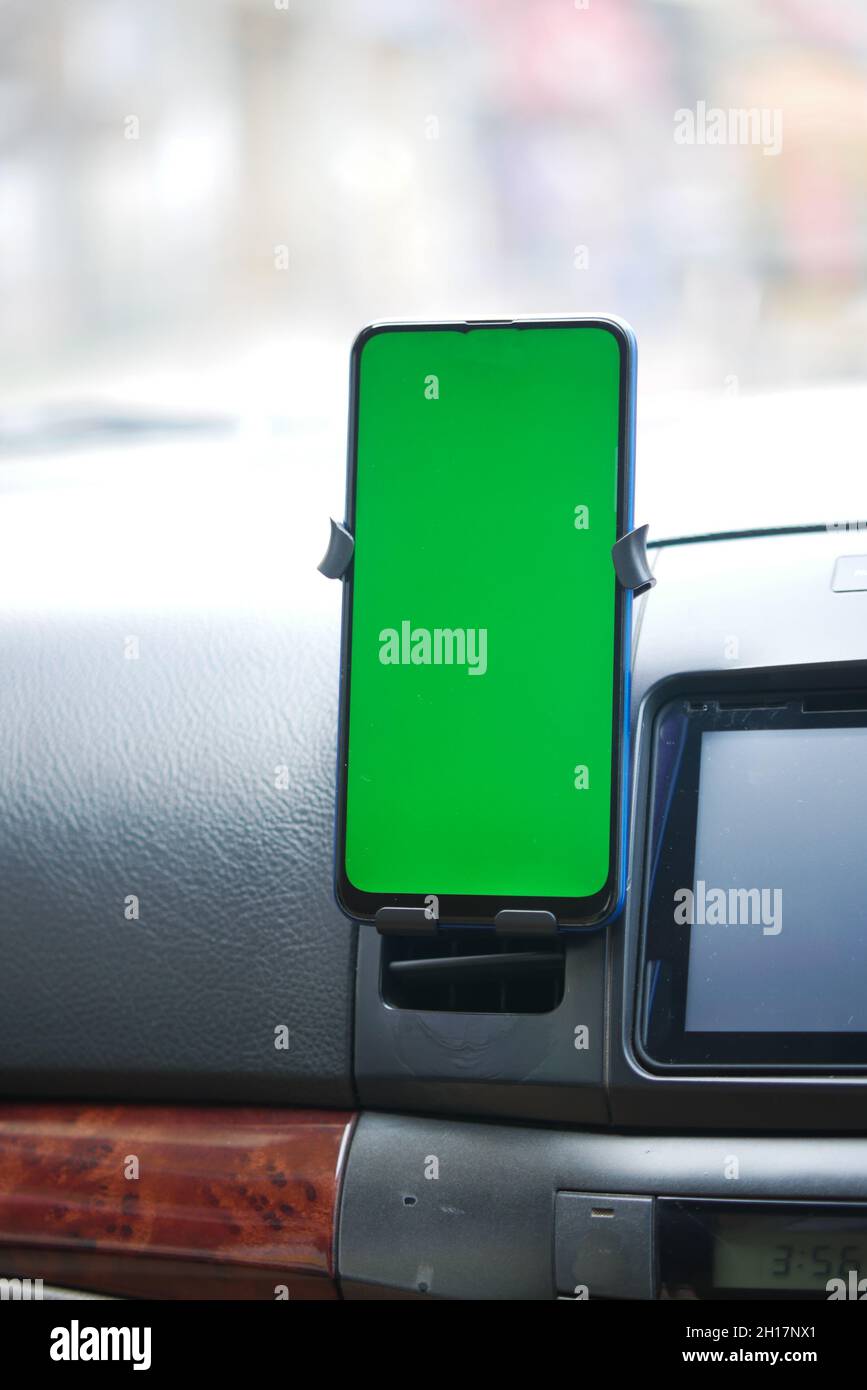 smart phone with green screen on car dashboard Stock Photo - Alamy