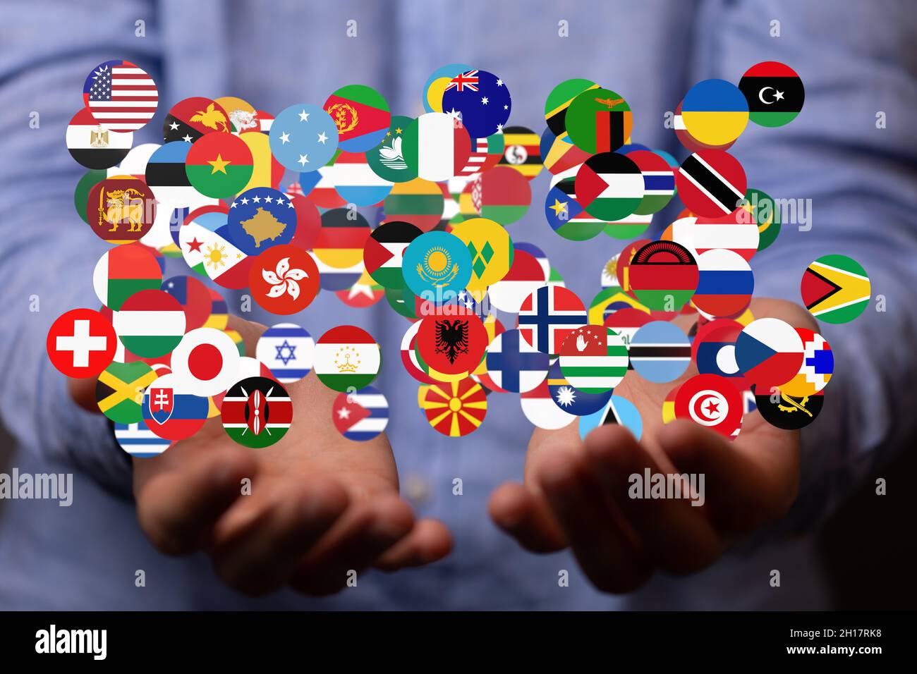 A 3D rendering of the world's national flags on a blurry background ...