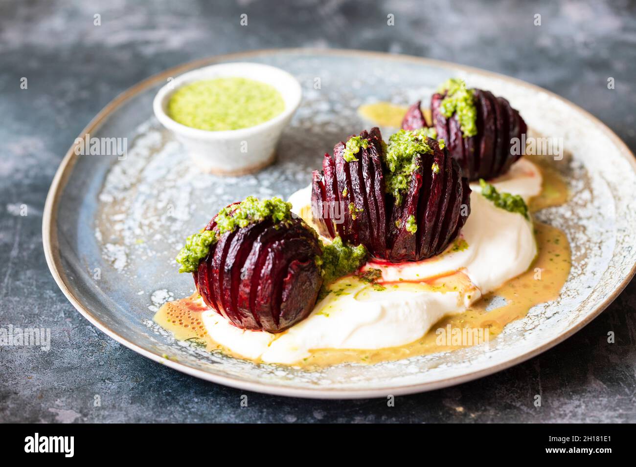Hasselback roast beetroot with yogurt and herb sauce Stock Photo - Alamy