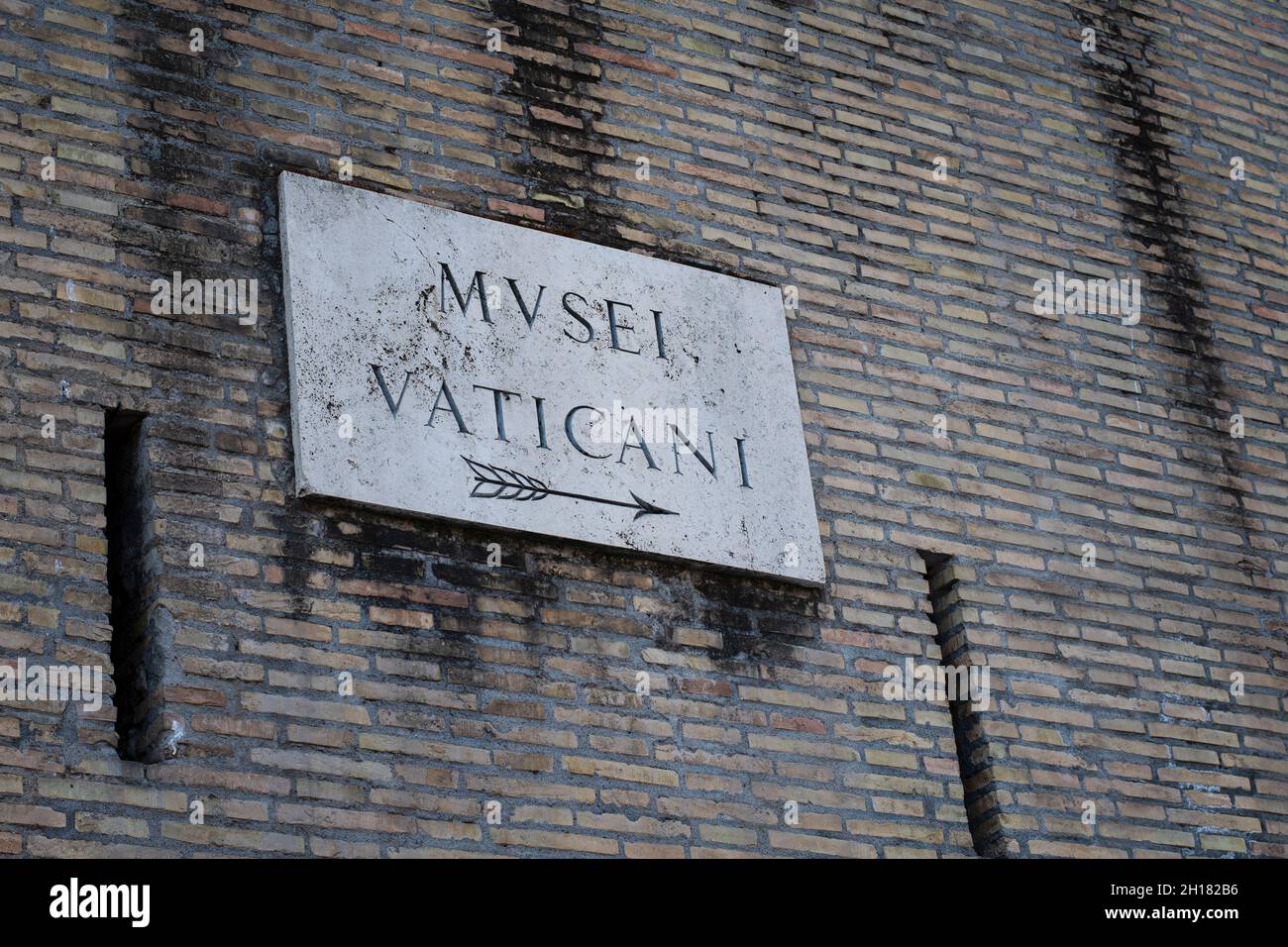 Old sign on the wall pointing out the direction to the Vatican Museum ...