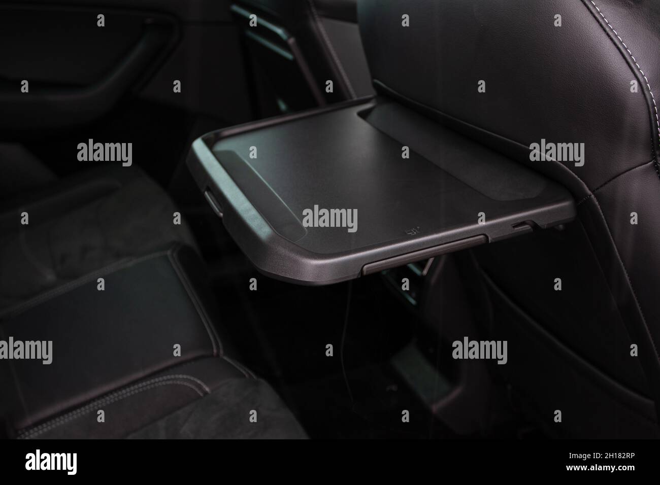 Car folding table inside modern car interior. Folding table on the back ...