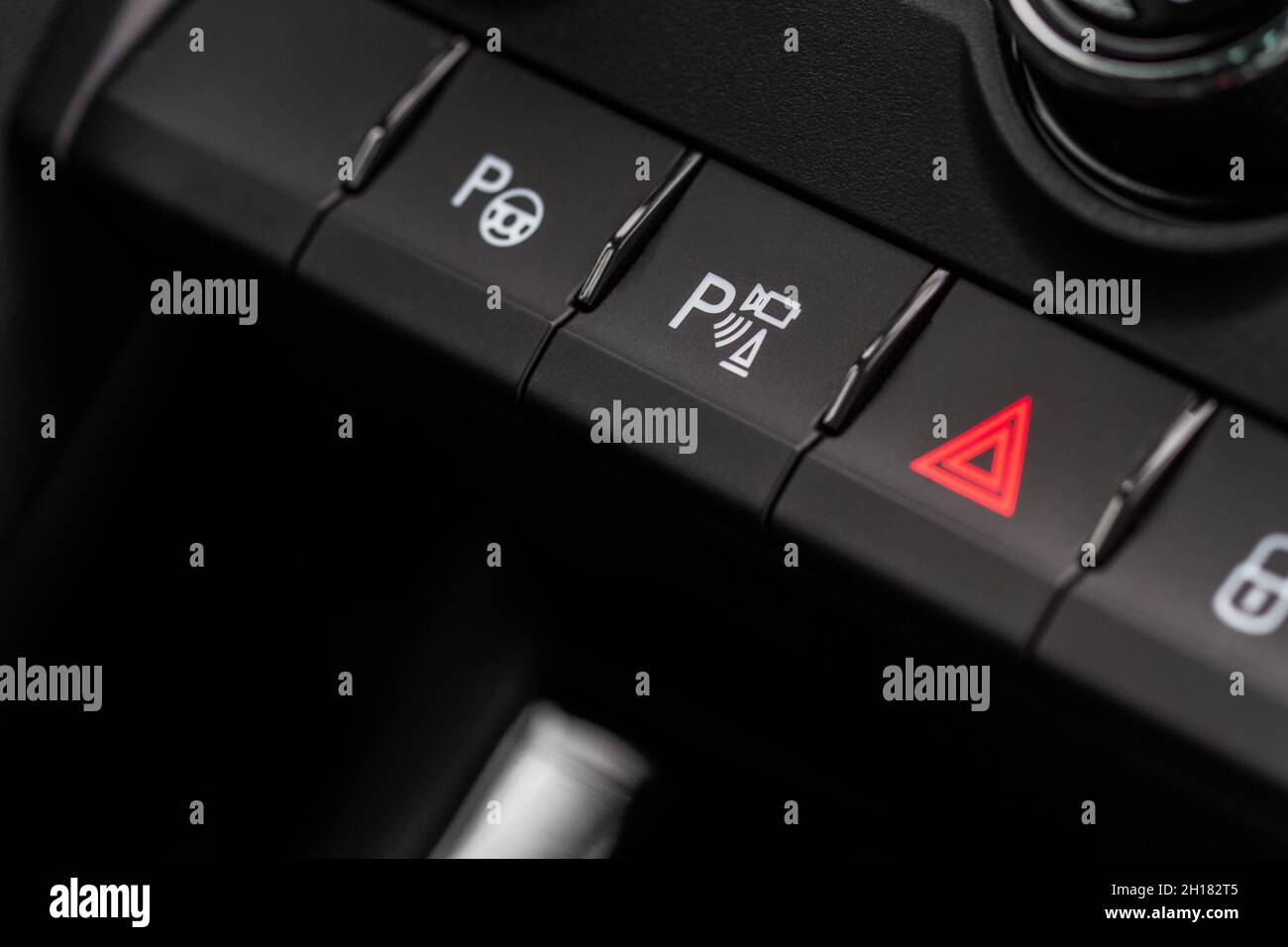 Hand operating ESP (electronic stability program) control close up view ...