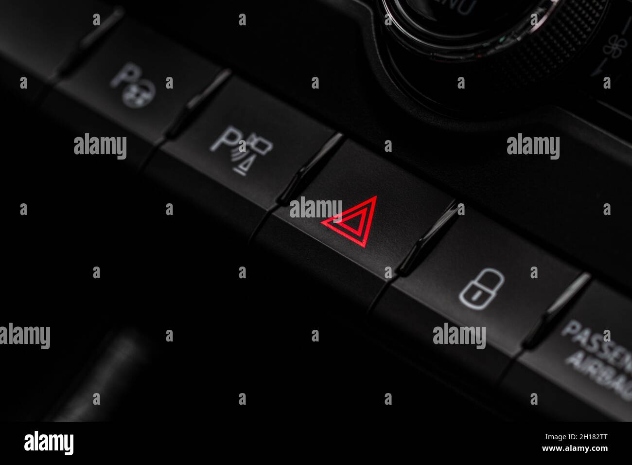 Red triangle hazard light button on car dashboard. Car media buttons ...