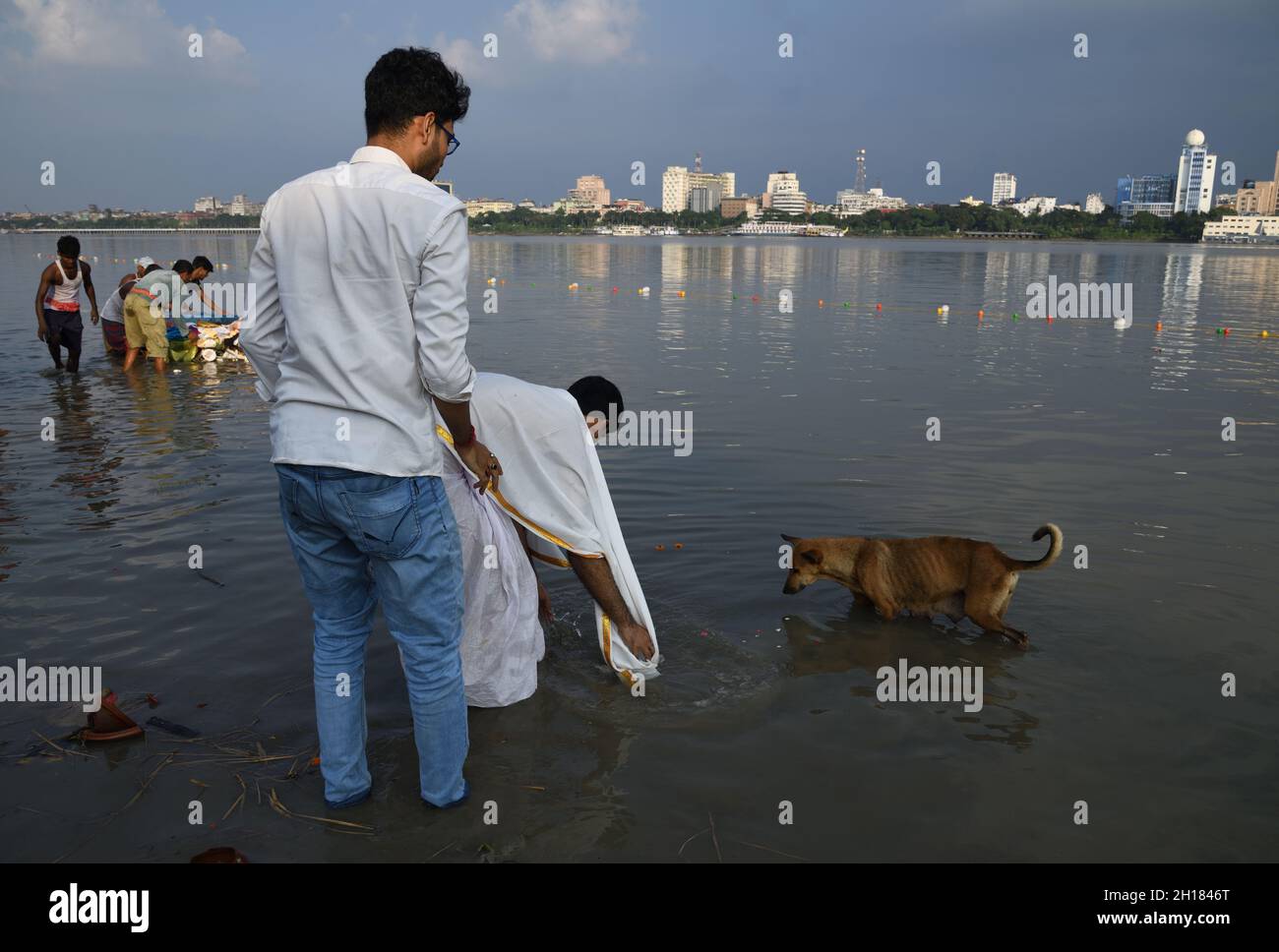 The Asthi or remnant of the dead body after burning is being immersed ...
