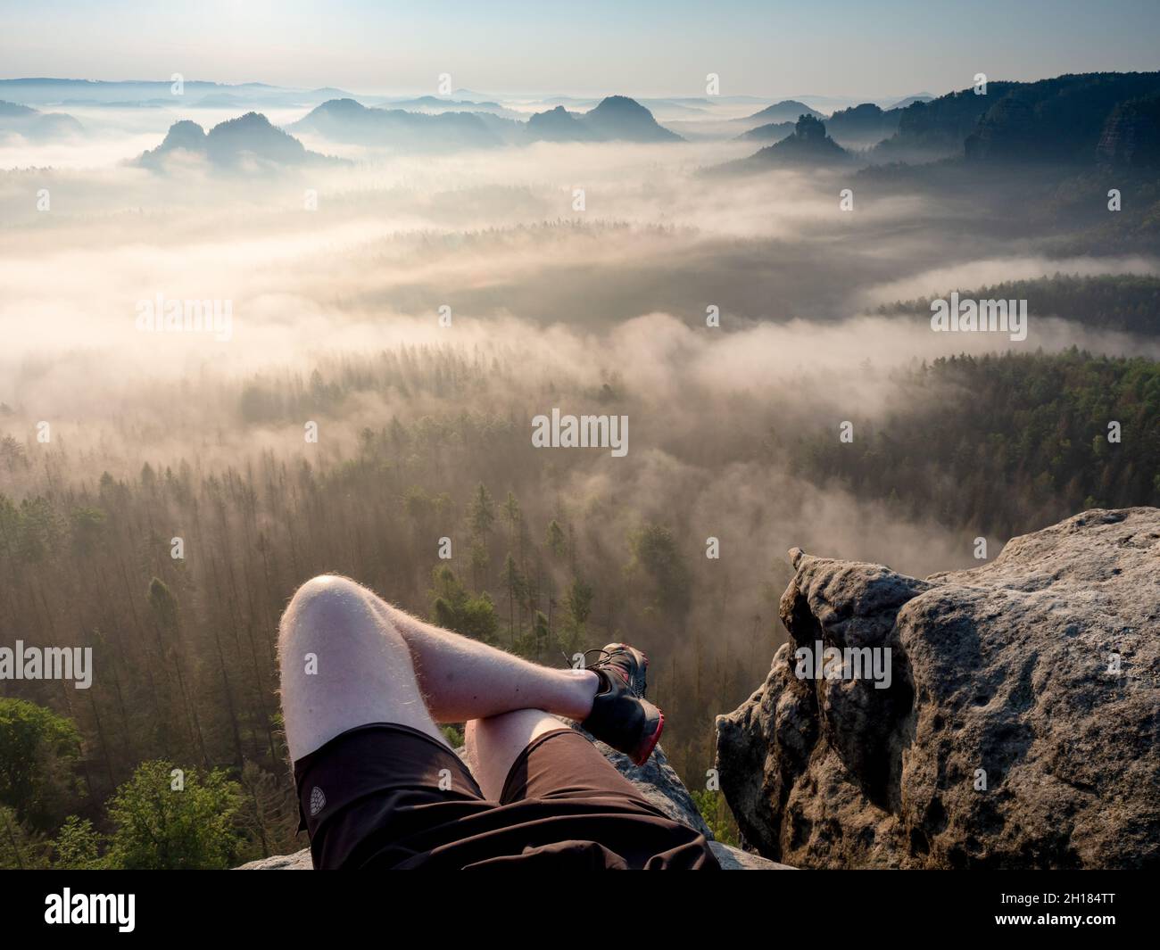 Stop during trek and resting close to cliff above deep gulch. Morning ...