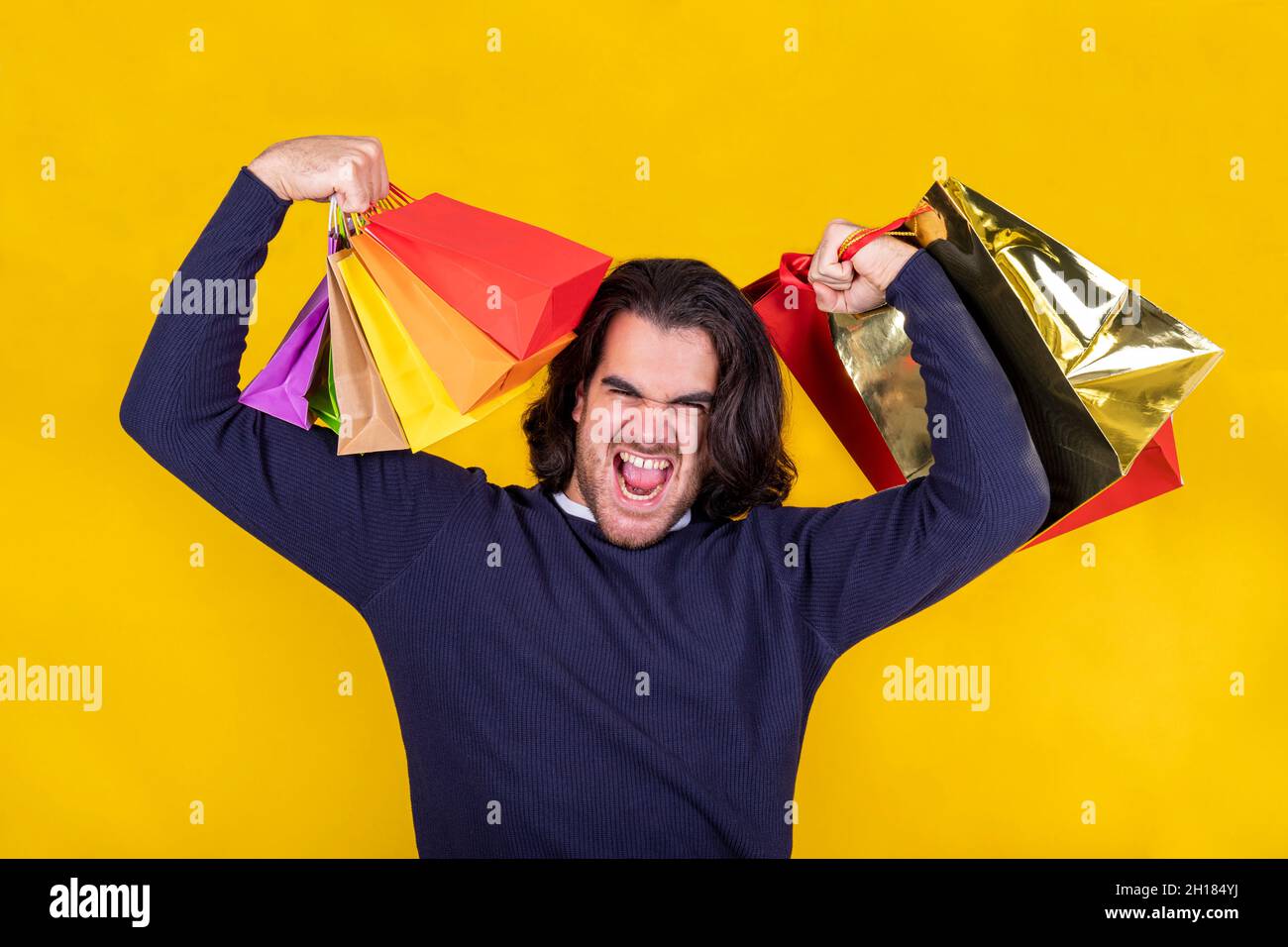Hurray! A young man expressing his joy and satisfaction by raising his ...