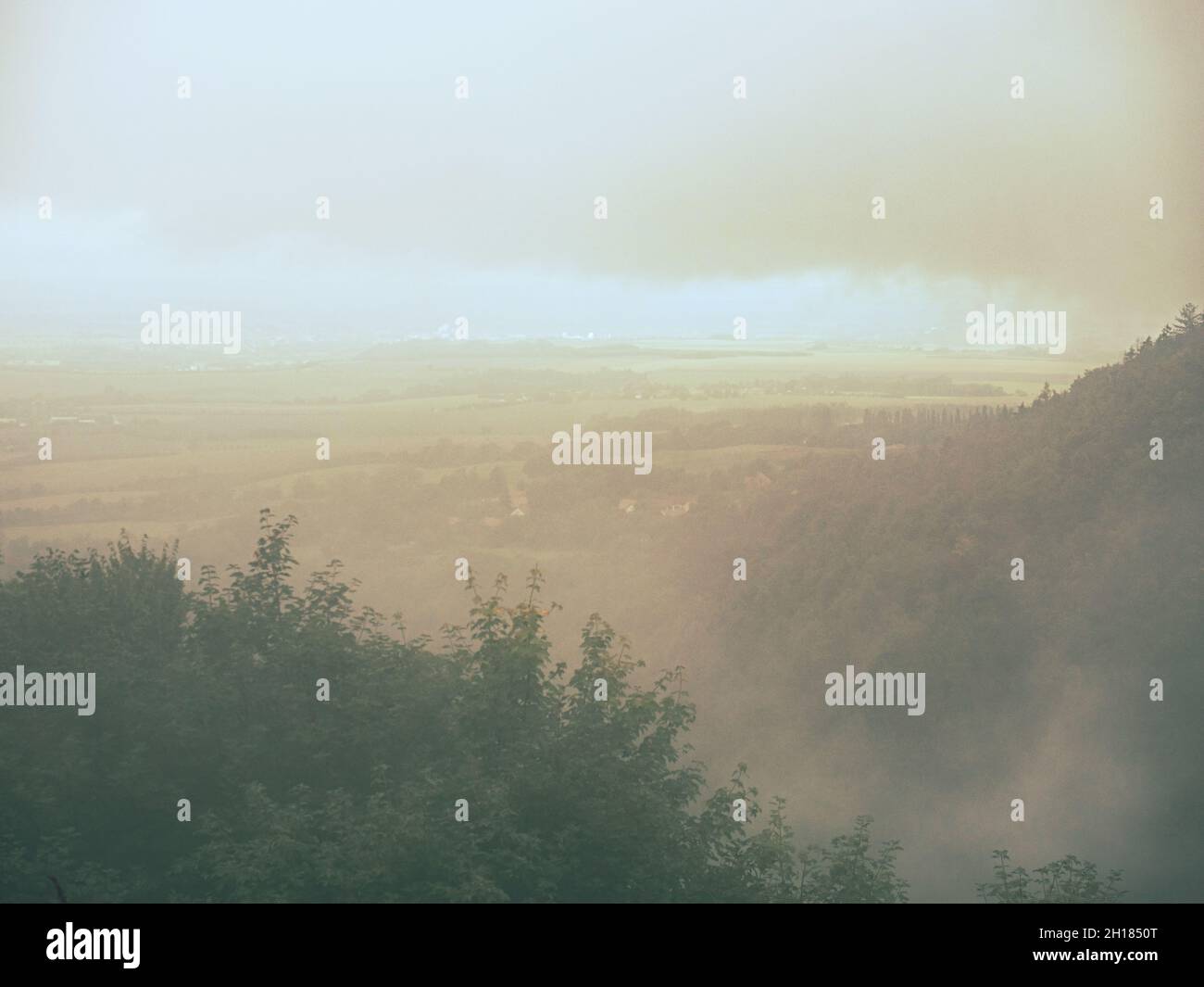 Red mist valley. Strange weather inversion with heavy clouds, mist and ...