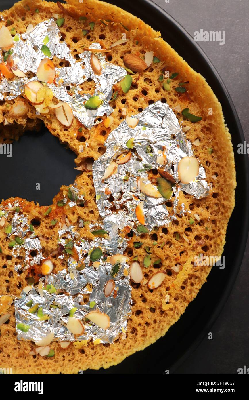 Rajasthani Ghevar. Ghewar is an Indian crunchy sweet dish made using ...