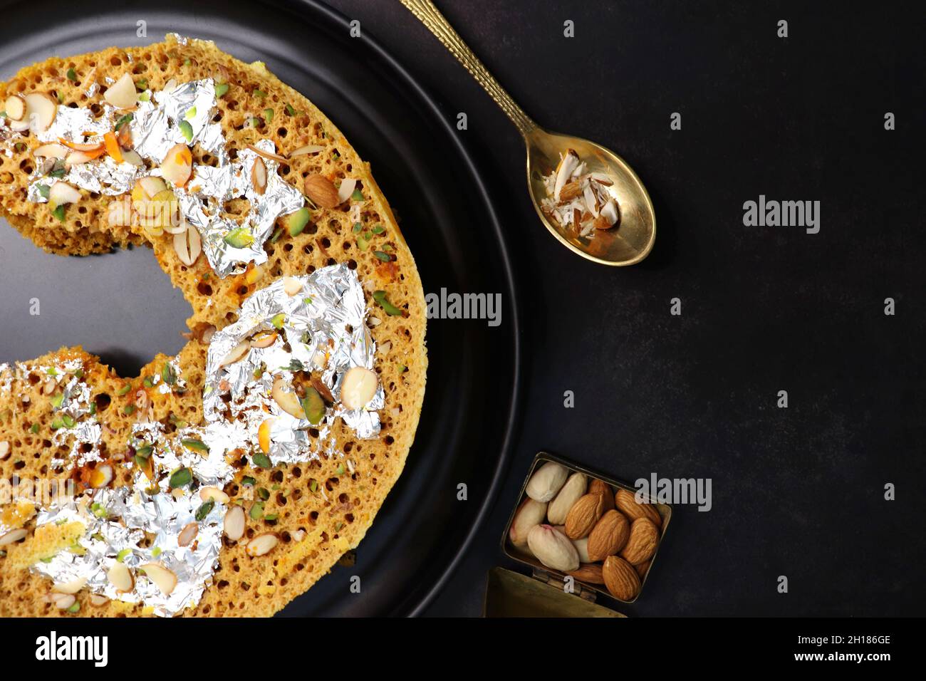 Rajasthani Ghevar. Ghewar is an Indian crunchy sweet dish made using ...