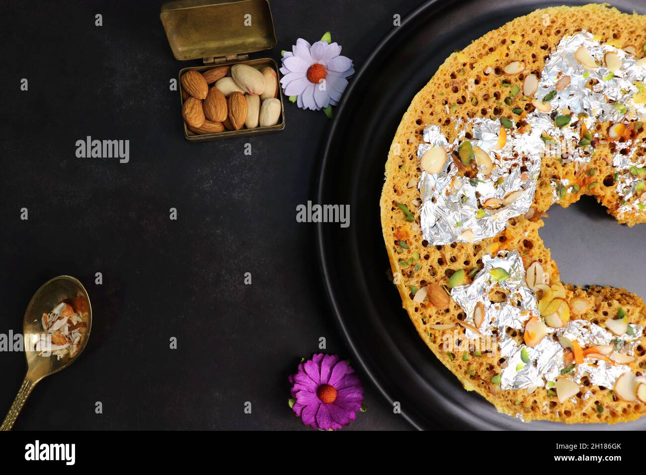 Rajasthani Ghevar. Ghewar is an Indian crunchy sweet dish made using ...