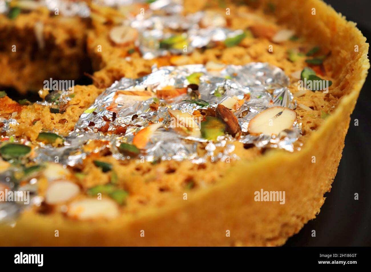 Rajasthani Ghevar. Ghewar is an Indian crunchy sweet dish made using ...