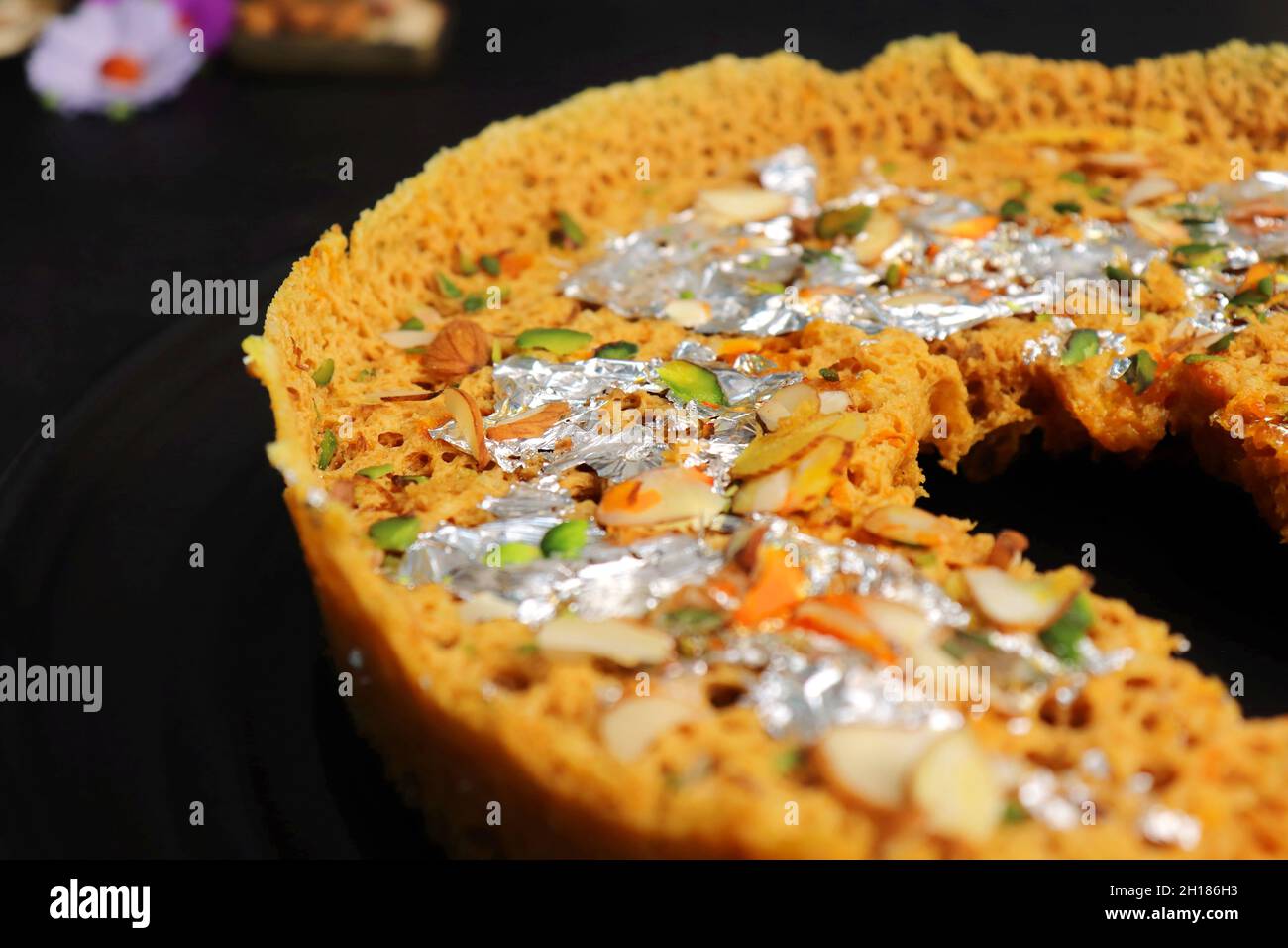 Rajasthani Ghevar. Ghewar is an Indian crunchy sweet dish made using ...