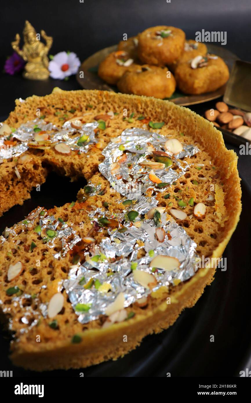 Rajasthani Ghevar. Ghewar is an Indian crunchy sweet dish made using ...
