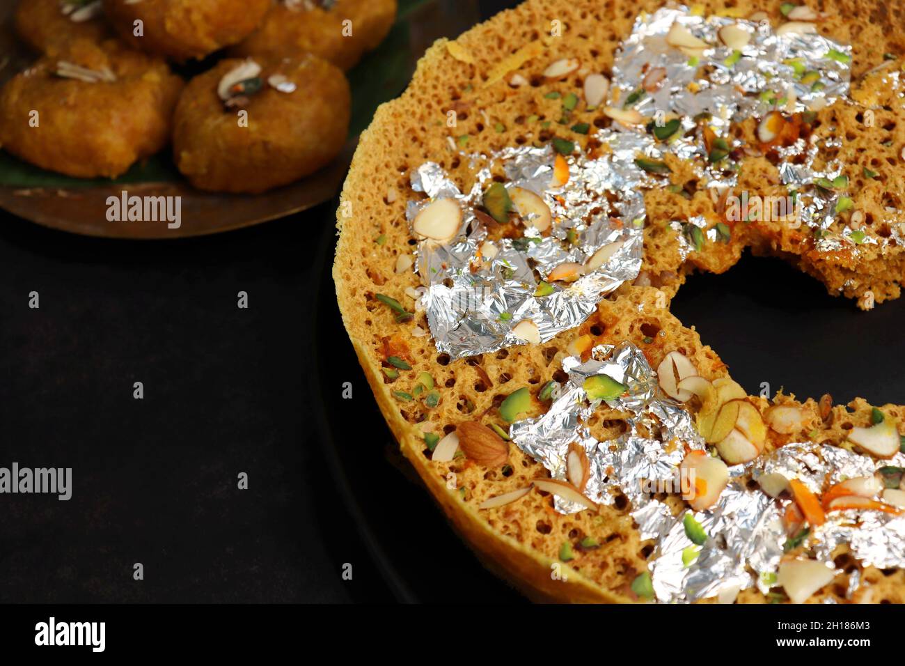 Rajasthani Ghevar. Ghewar is an Indian crunchy sweet dish made using ...