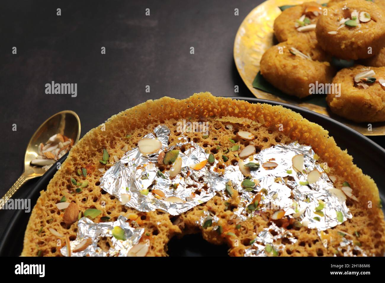 Rajasthani Ghevar. Ghewar is an Indian crunchy sweet dish made using ...