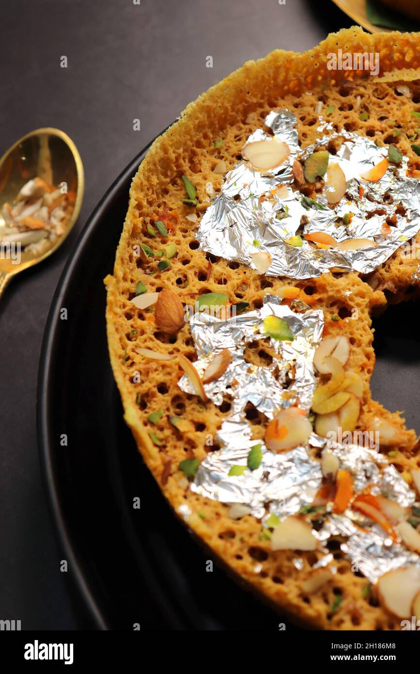 Rajasthani Ghevar. Ghewar is an Indian crunchy sweet dish made using ...