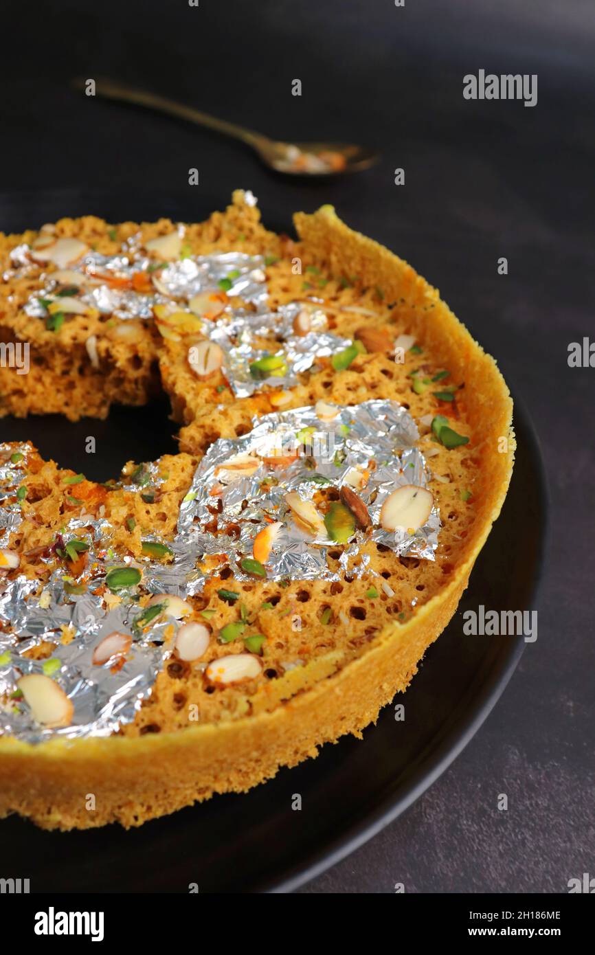 Rajasthani Ghevar. Ghewar is an Indian crunchy sweet dish made using ...
