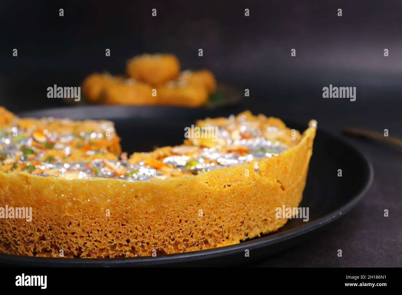 Rajasthani Ghevar. Ghewar is an Indian crunchy sweet dish made using ...