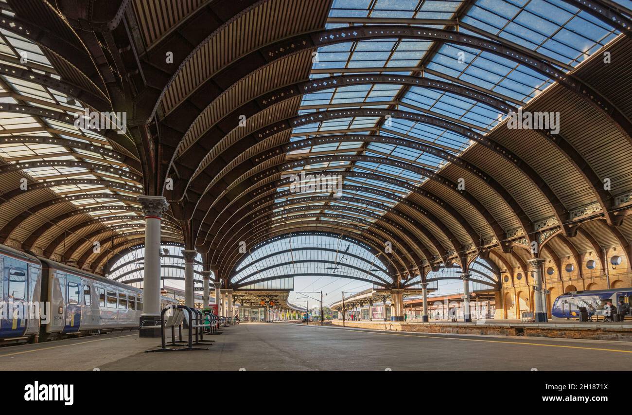 A panorama of a railway station concourse. An 19th century iron canopy ...