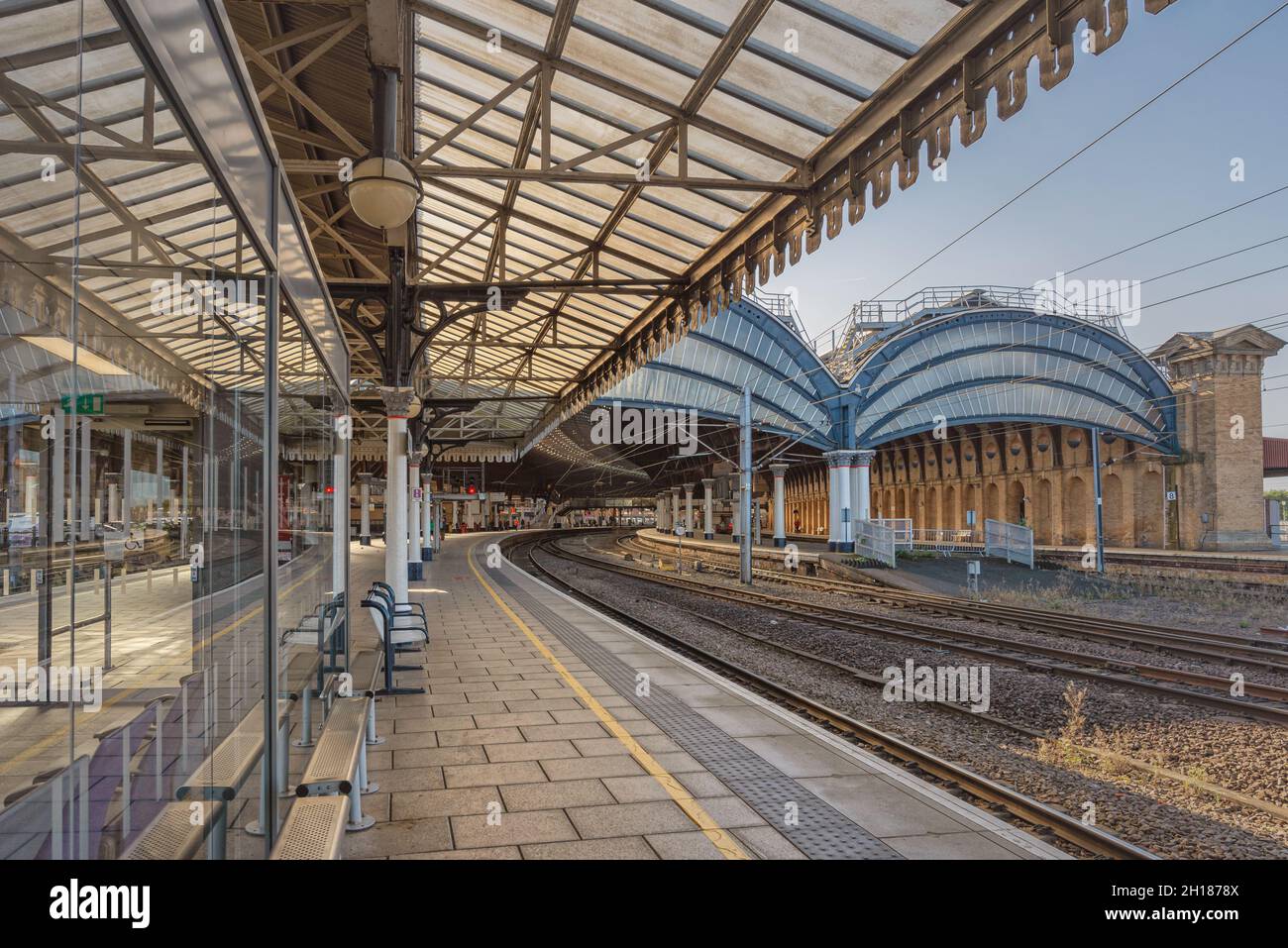 View of a railway station with historic canopies and a mirror image or ...
