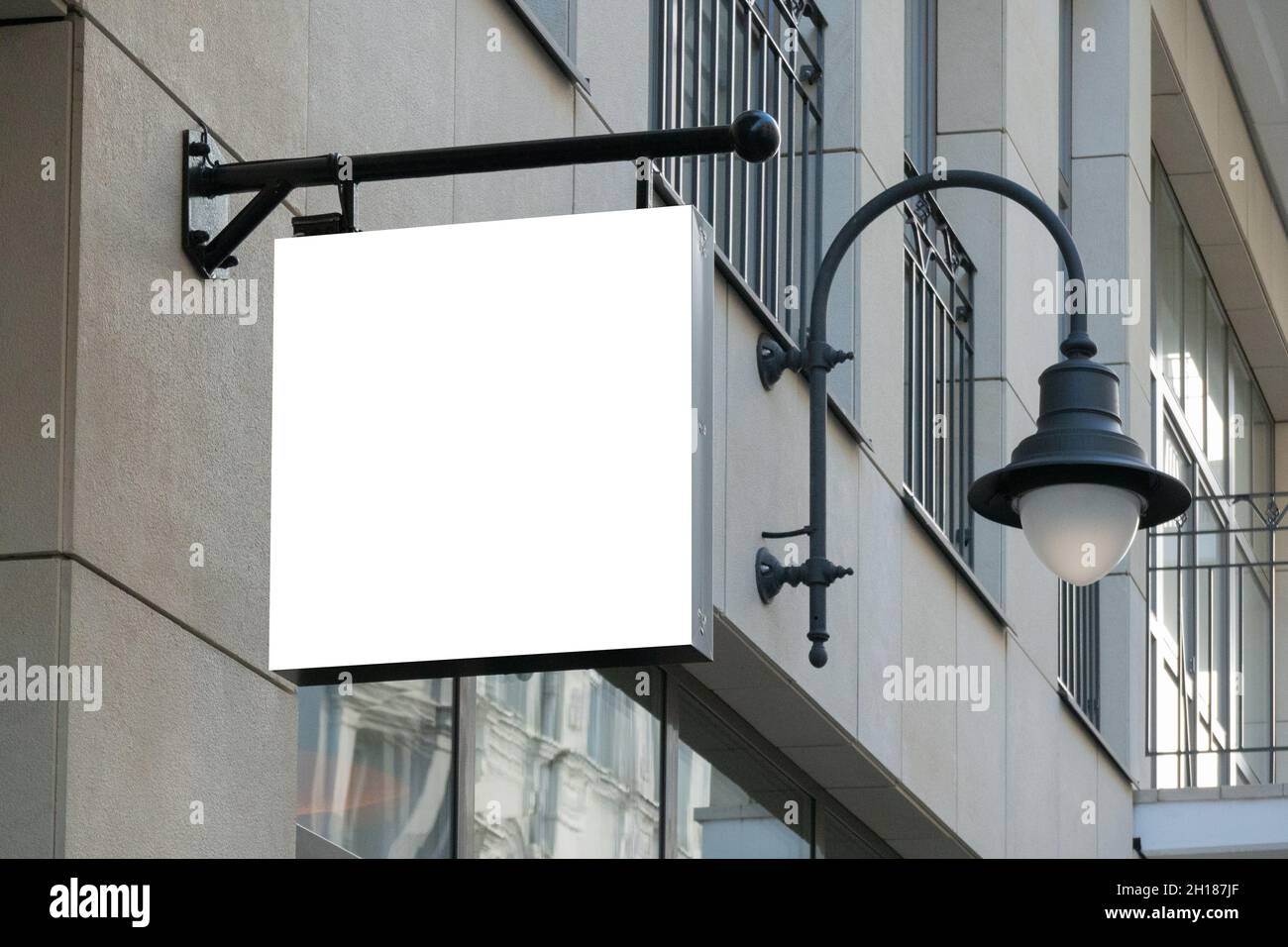 Mock up. Blank white rectangular shape signboard on the wall outdoors ...