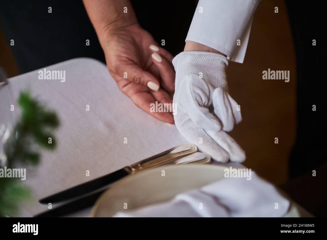 Restaurant personnel preparing the fine dining table Stock Photo - Alamy