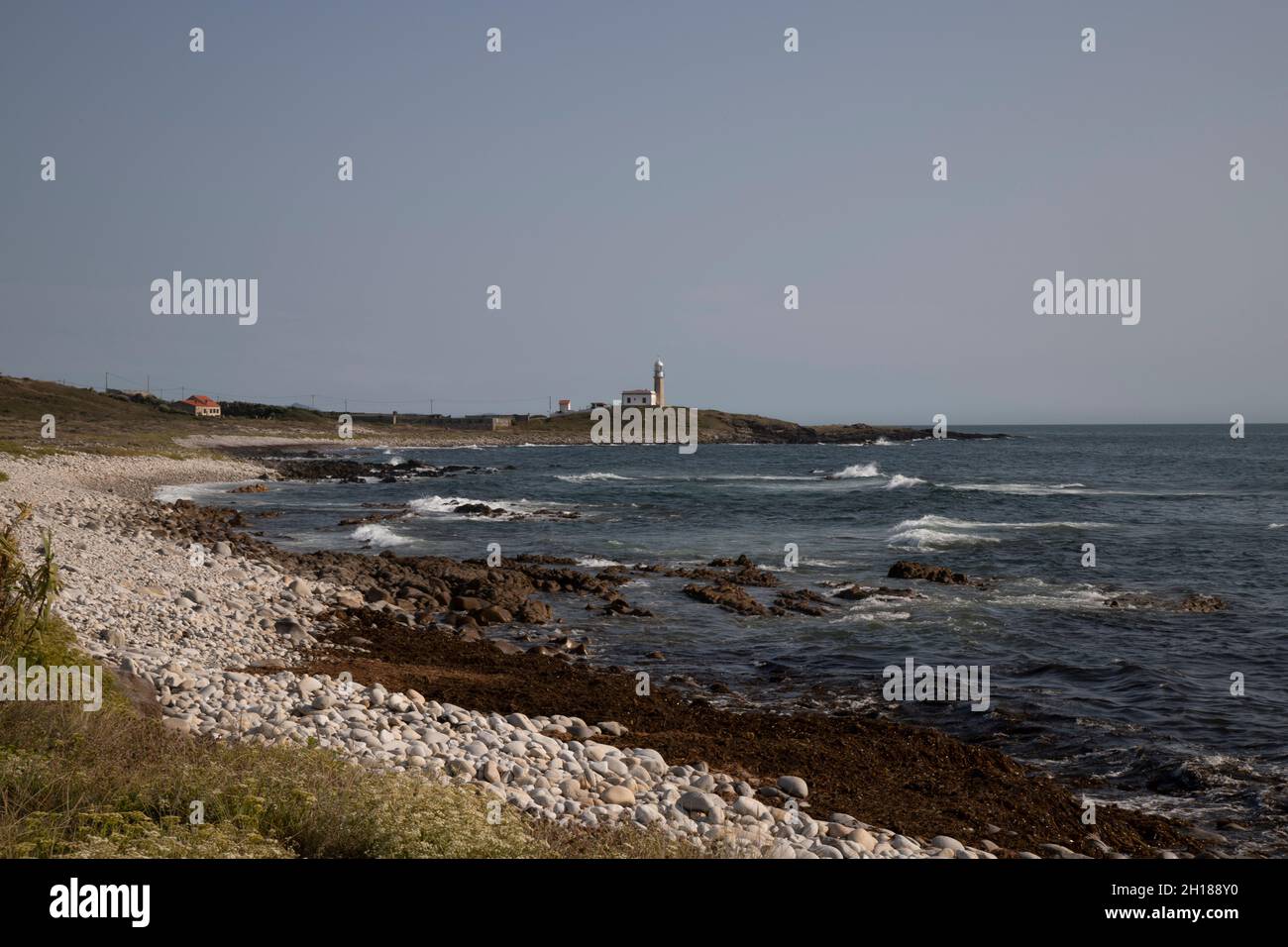 Seascape showing a lighthouse and some rocks in Lariño town in Galician ...