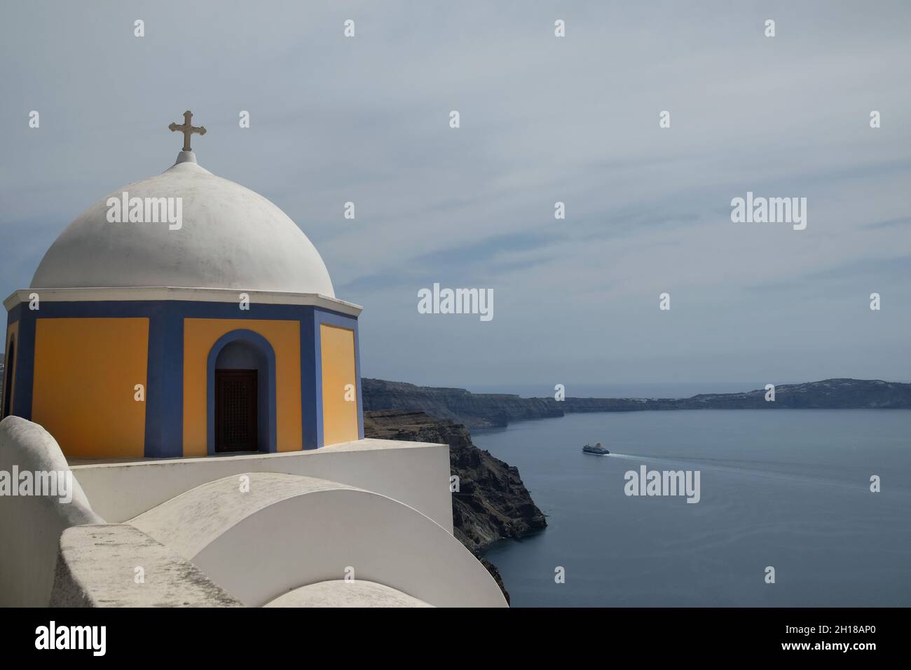 View of a colorful orthodox church and a ferry boat in the distance in ...