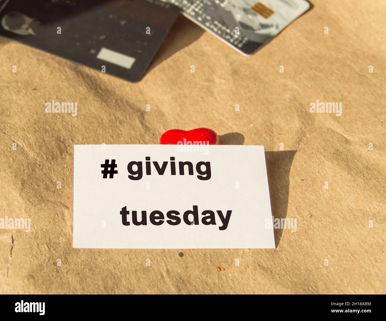 A white letterhead with the hashtag giving on Tuesday and bank cards on ...