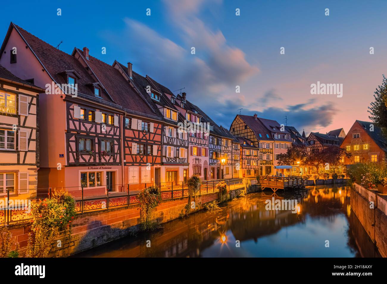 An evening at Colmar, with traditional colorful half-timbered houses in ...