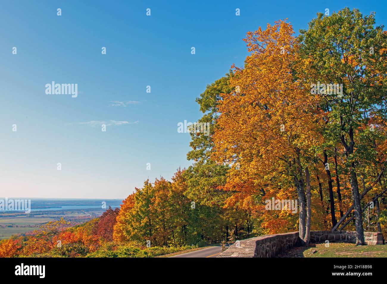 Fall foliage and a blue sky from a lookout in autumn at Gatineau Park ...