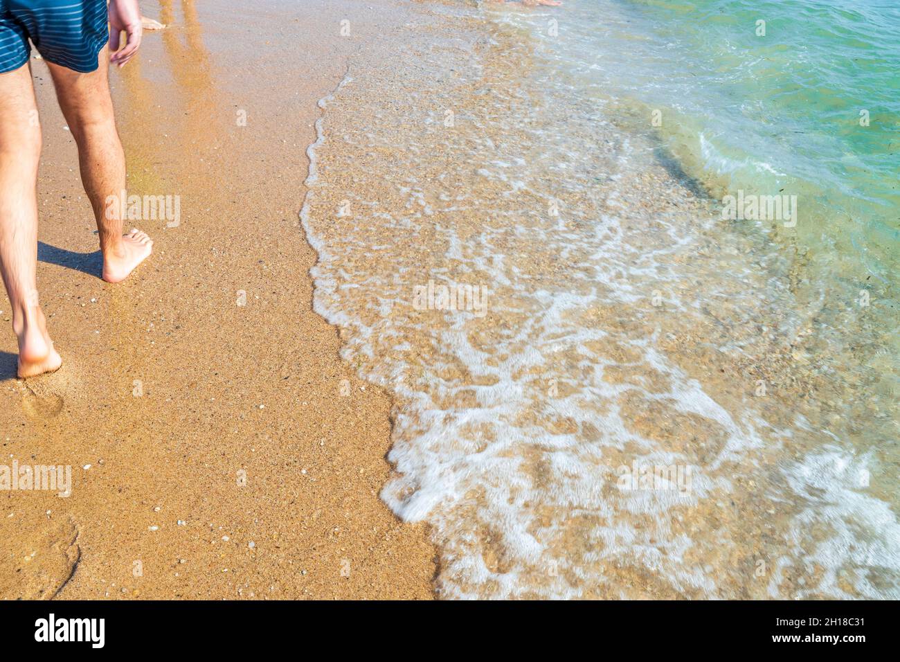 Man walking along a tropical beach hi-res stock photography and images ...