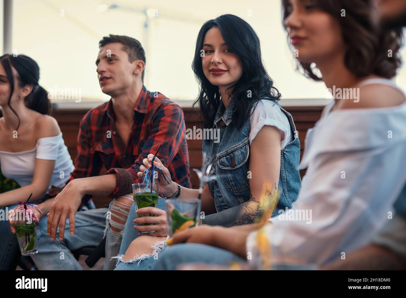Having a rooftop party. Happy young people drinking cocktails and ...
