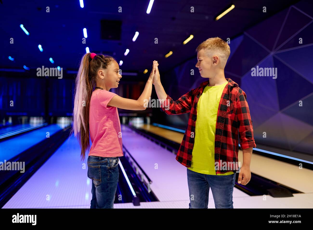 Children play bowling, game center, little bowlers Stock Photo - Alamy
