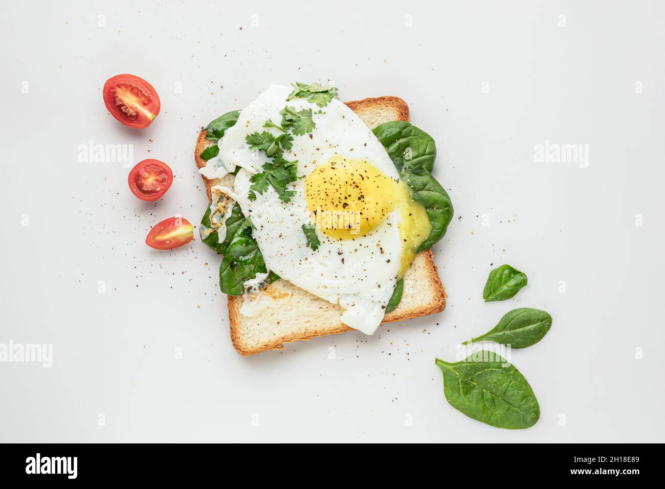 toast with fried egg and spinach. minimalistic food art healthy food ...