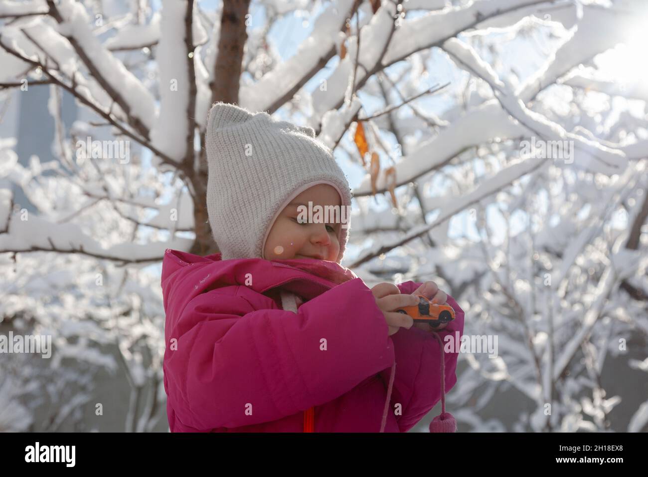 Outdoor winter portrait of little healthy happy baby child walking in ...
